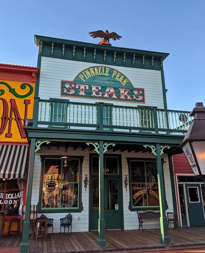 As the sun sets, Pinnacle Peak's iconic facade glows with promise. That eagle on top isn't just decoration—it's guarding the steaks.