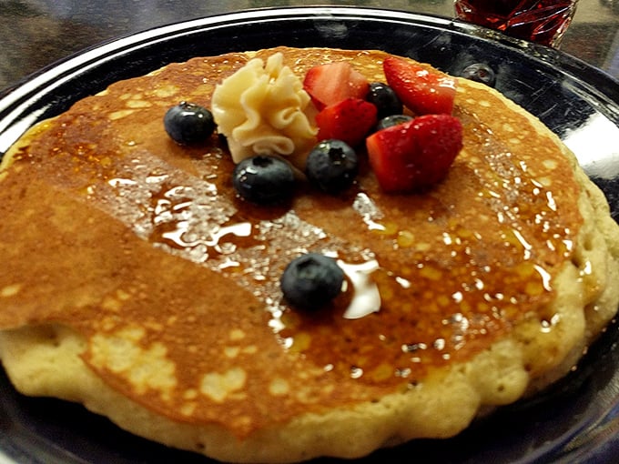 A pancake that understands the importance of accessorizing. Those fresh berries aren't just garnish – they're jewelry for your breakfast.
