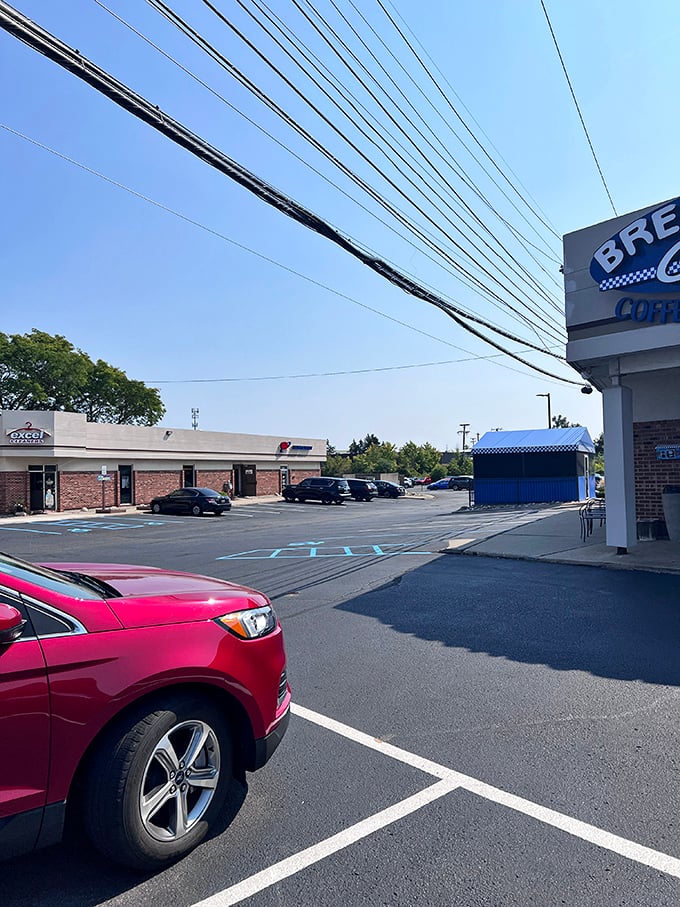 Even the parking lot feels welcoming, with the blue awning hinting at the breakfast paradise that awaits just steps away.