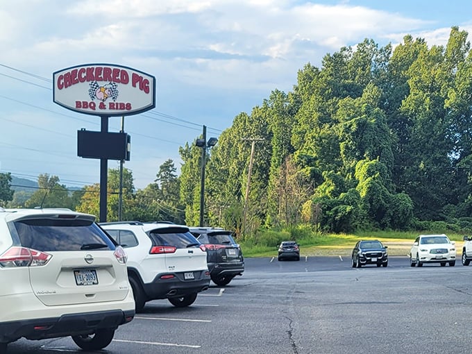 A packed parking lot is the universal sign for "you've found the good stuff." The roadside sign stands tall, guiding hungry travelers to barbecue salvation. 