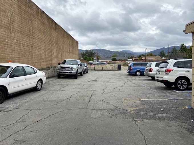 The humble parking area behind The Donut Man – where vehicles of all types converge with one delicious mission in mind.