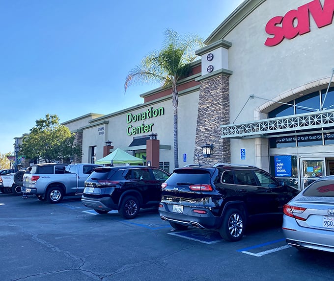 The parking lot view reveals both the shopping and donation entrances—the alpha and omega of the thrifting lifecycle under perfect California skies.