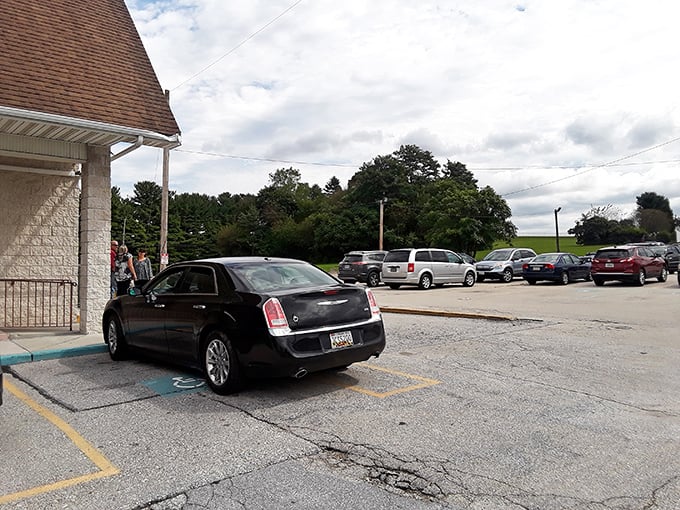 A parking lot that tells the real story—packed with vehicles from work trucks to sedans, because good food crosses all demographic lines.