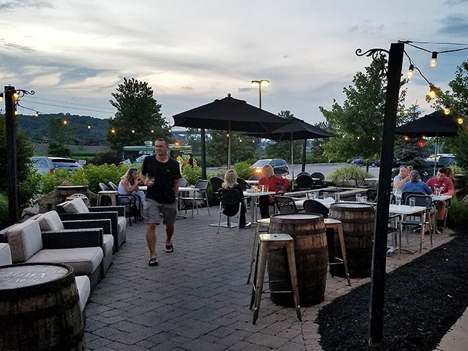 As evening settles in, the patio transforms into an outdoor living room where conversations flow as freely as the drinks.