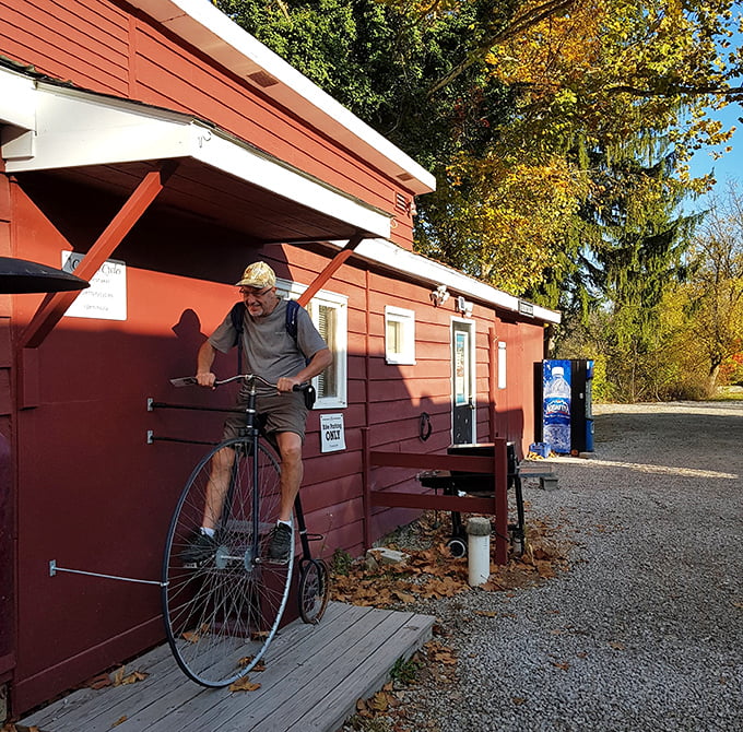 History meets whimsy outside this depot where a gentleman demonstrates a penny-farthing bicycle—transportation's evolutionary branch that thankfully didn't stick around.