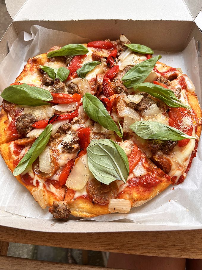 A personal pizza topped with fresh basil leaves—proof that Lorenzo's can do both straightforward classics and elevated variations with equal skill.