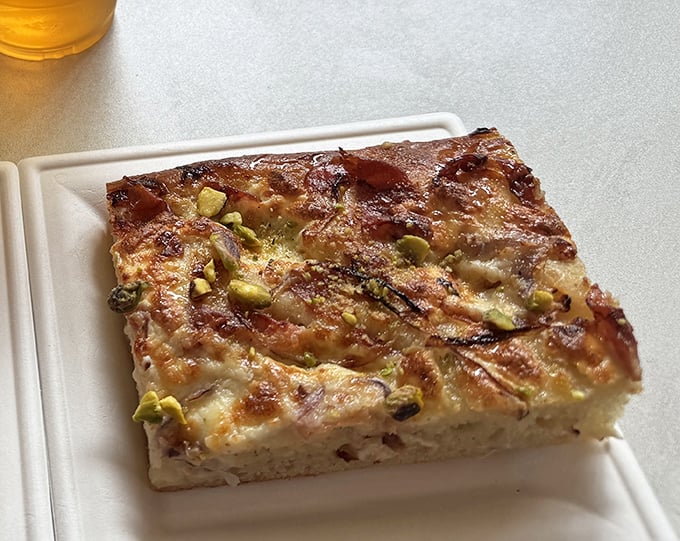 This savory square of heaven proves that quiche isn't just for brunch – it's an anytime indulgence worth crossing town for.