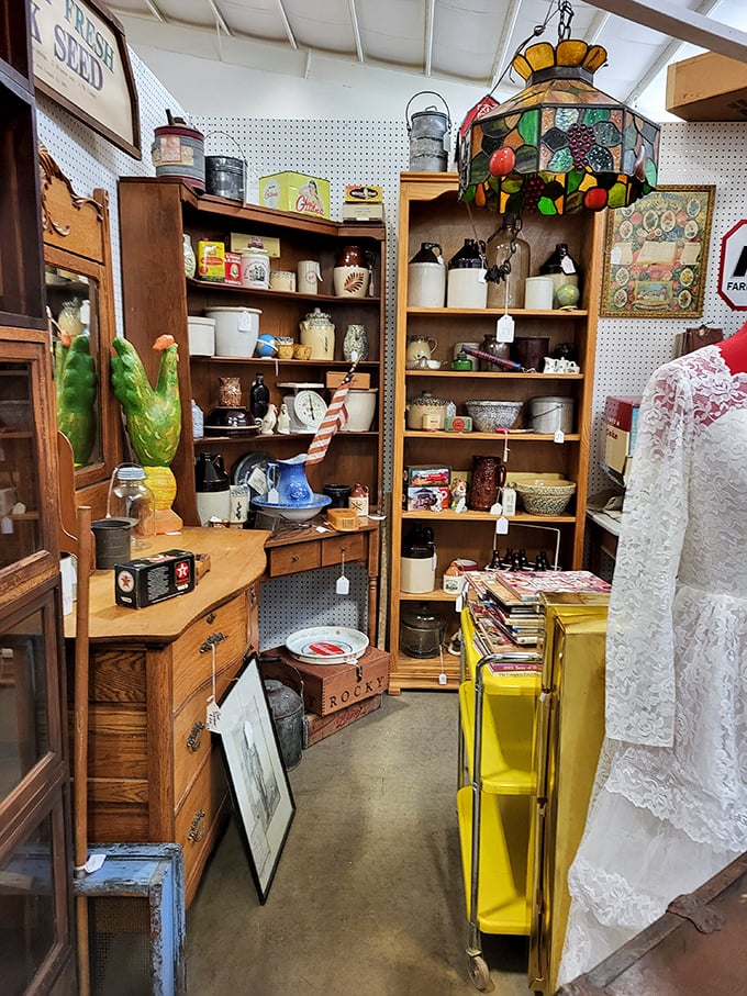 This cozy nook of farmhouse treasures feels like stepping into your grandmother's pantry. That stained glass lamp casts the perfect warm glow.