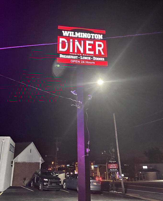 The 24-hour sign glows like a lighthouse for the hungry at night—a promise that pancakes and possibility await, no matter the hour.