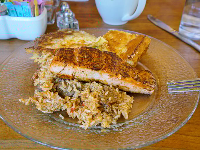 Blackened salmon resting on a bed of rice like it owns the place. The fish didn't swim upstream for nothing—it earned this delicious finale. 