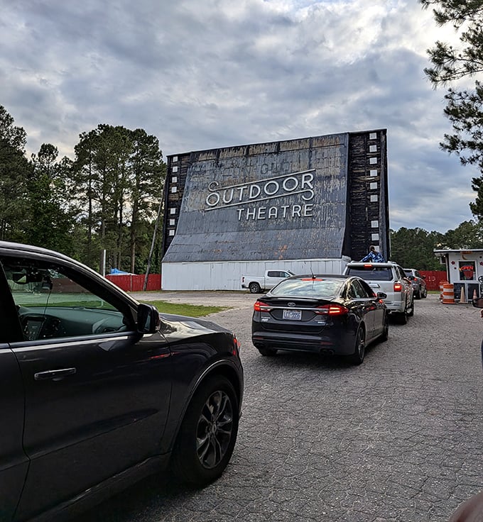 The pilgrimage begins—cars line up for their spot at this cinematic sanctuary where movie magic still happens the old-fashioned way.