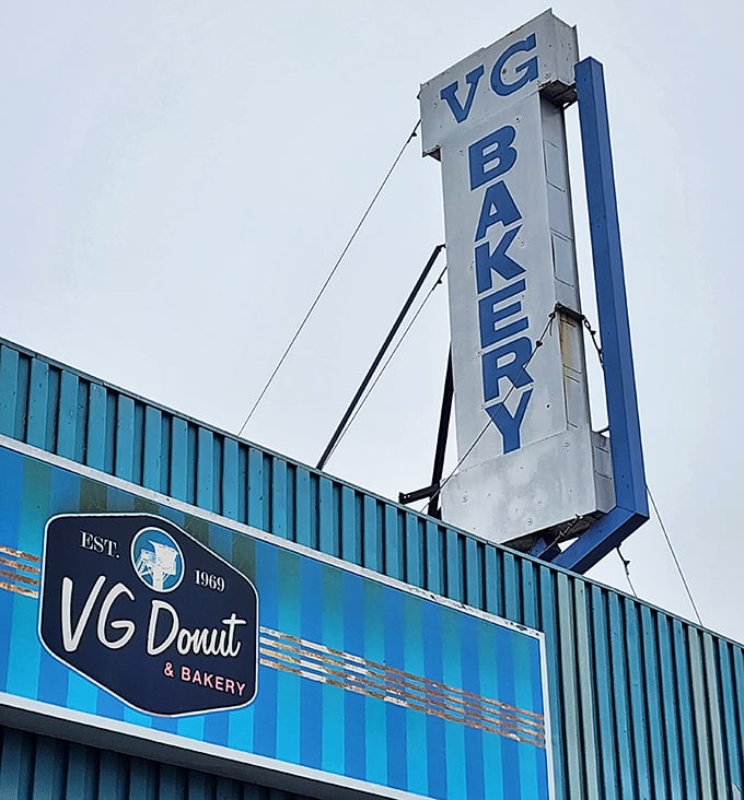 That vintage-style sign stands tall like a lighthouse, guiding sugar seekers safely to their glazed destination since 1969.