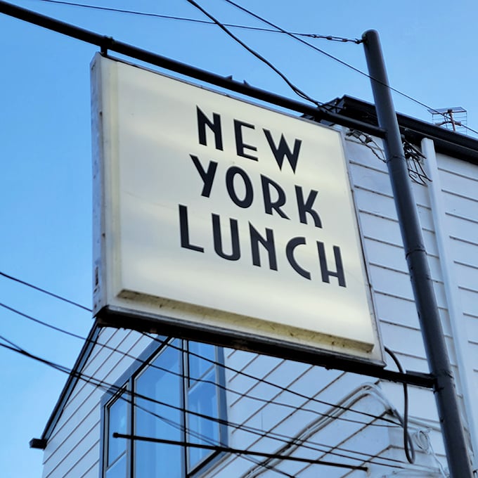 The sign glows like a beacon for the hungry and weary. Simple, straightforward, and promising exactly what it delivers.