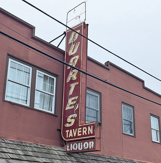That vertical neon sign has guided hungry travelers to this coastal haven for generations – a beacon of culinary promise against the foggy sky.