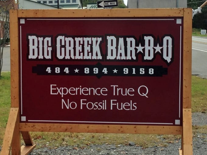 "Experience True Q, No Fossil Fuels"—a roadside promise that separates the authentic wood-smoking believers from the gas-assisted pretenders.