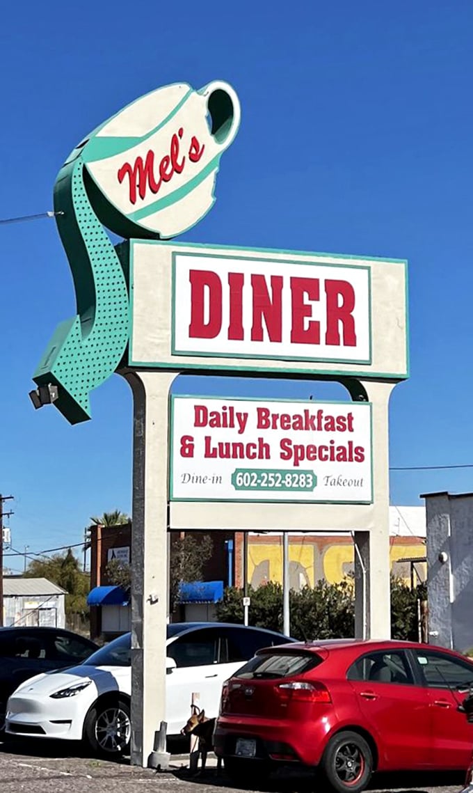 The iconic coffee cup sign stands tall against the Arizona blue—a beacon of breakfast hope for hungry travelers and locals alike.