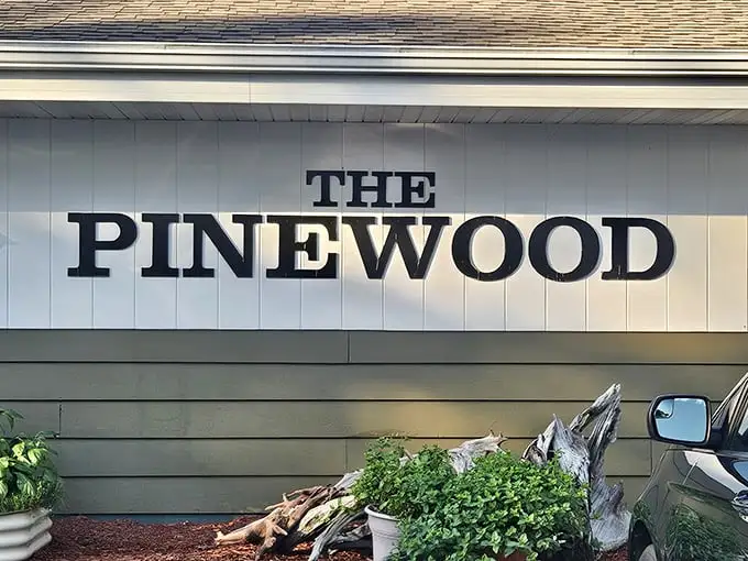 The sign says "Pinewood" but might as well read "You've Arrived"—the gateway to a Wisconsin dining institution where hunger goes to surrender.