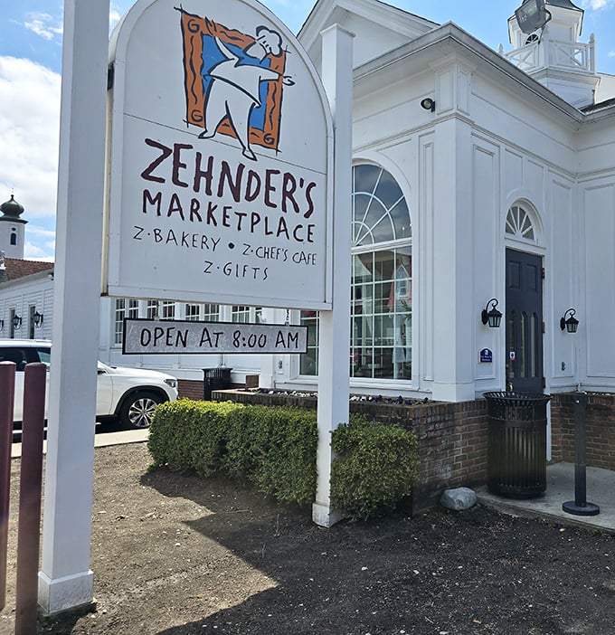 The Zehnder's Marketplace sign promises additional temptations beyond the restaurant—because taking home bakery treats is practically mandatory when visiting this Michigan landmark. 