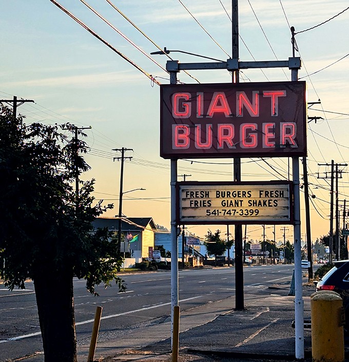 As dusk settles, the neon sign glows like a beacon for the burger-obsessed. "Fresh burgers, fresh fries, giant shakes"—a roadside haiku.