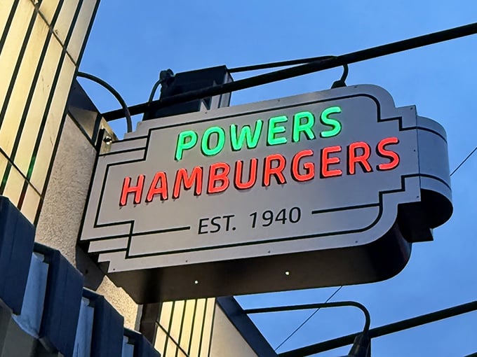 The neon sign glows like a beacon in the night, guiding hungry travelers to burger salvation since 1940.
