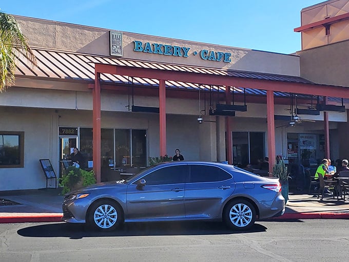 The "Bakery • Cafe" sign serves as a beacon of hope for the hungry and caffeine-deprived. Like a lighthouse, but for pastry emergencies.