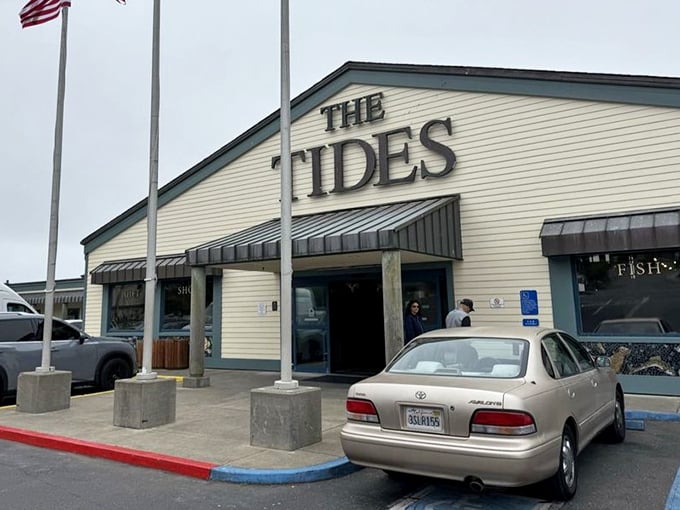 The Tides' welcoming façade stands like a beacon for hungry travelers—promising seafood salvation just beyond those blue-trimmed doors.
