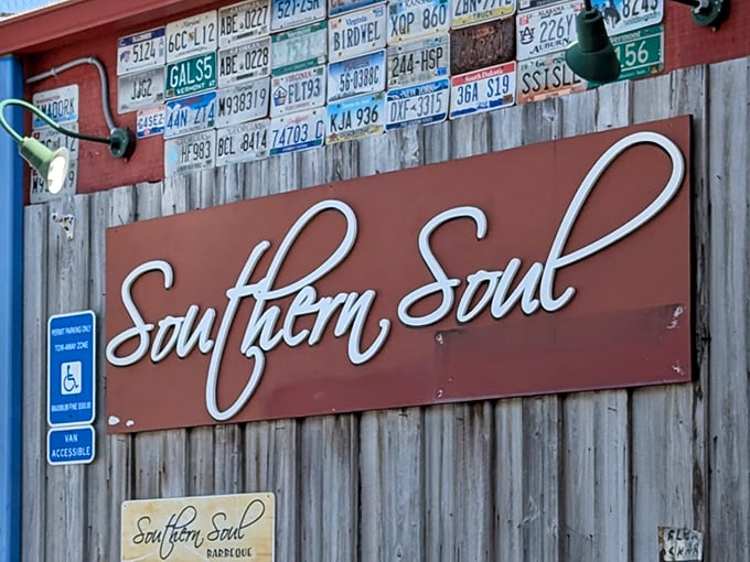 License plates above the sign tell you people come from everywhere for this barbecue. That elegant script promises food with both Southern hospitality and soul.