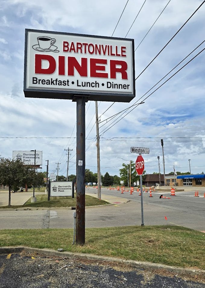The roadside sign stands as a beacon for hungry travelers and locals alike—"Breakfast • Lunch • Dinner" promising satisfaction at any hour.