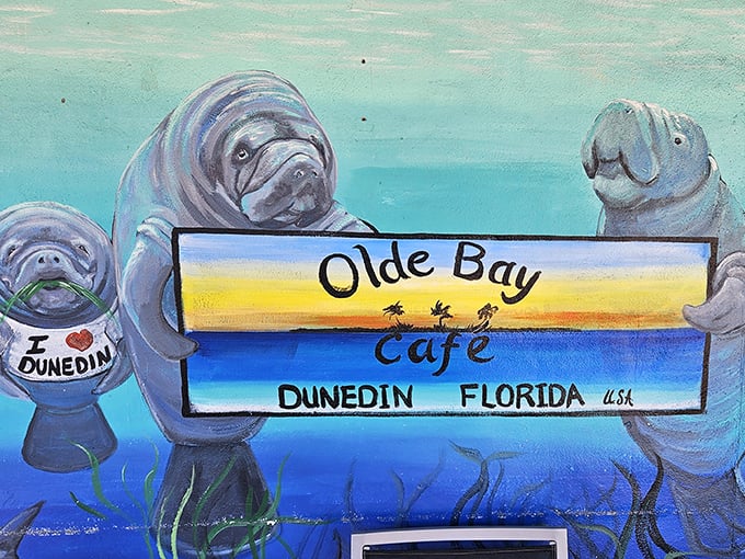 Local marine life gets artistic representation—these painted manatees aren't just mascots, they're the unofficial greeters of Dunedin's beloved waterfront eatery.