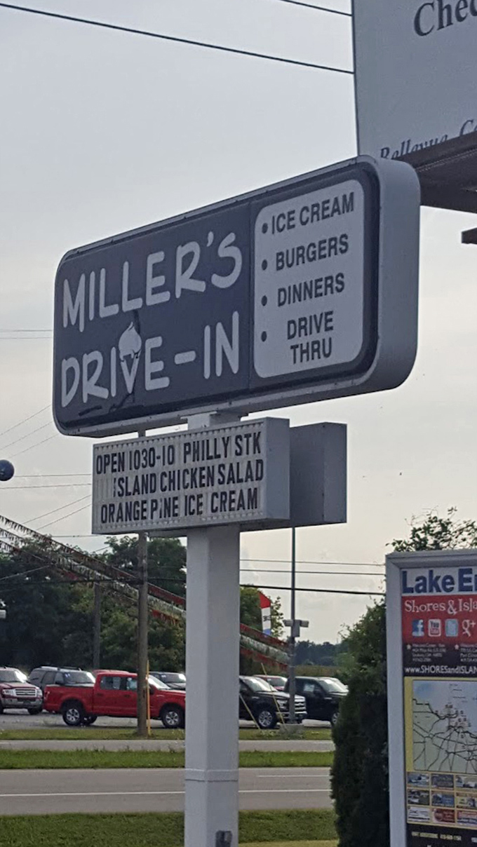 The roadside sign stands as a beacon of hope for hungry travelers—its simple message promising ice cream, burgers, and a brief escape from the ordinary.