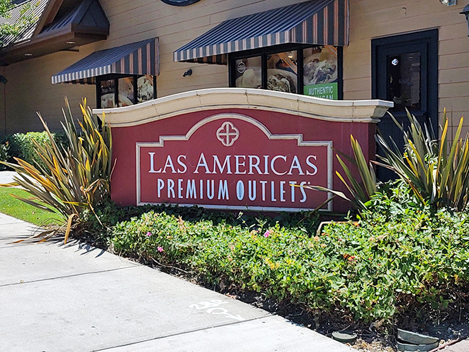 The welcoming sign that promises retail salvation – where San Diego sunshine meets discount designer goods in a match made in shopping heaven.
