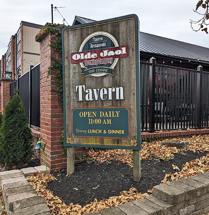 The weathered wooden sign stands sentinel, promising "Fine Cuisine" – a humble understatement for what awaits inside these brick walls.