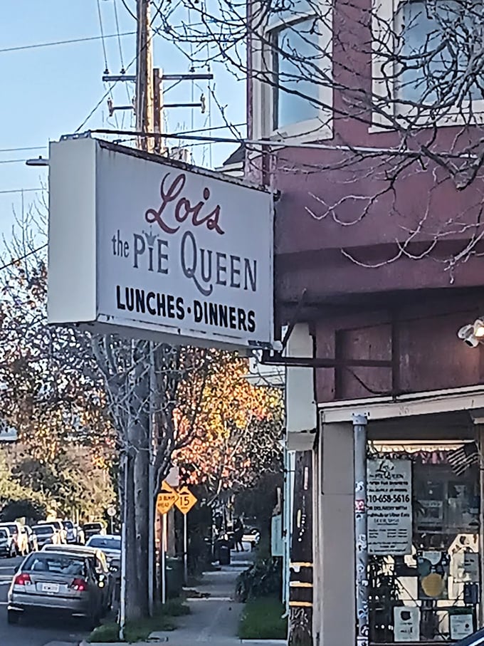 The sign that promises more than food – it offers a royal decree that comfort, community, and killer pie await inside.