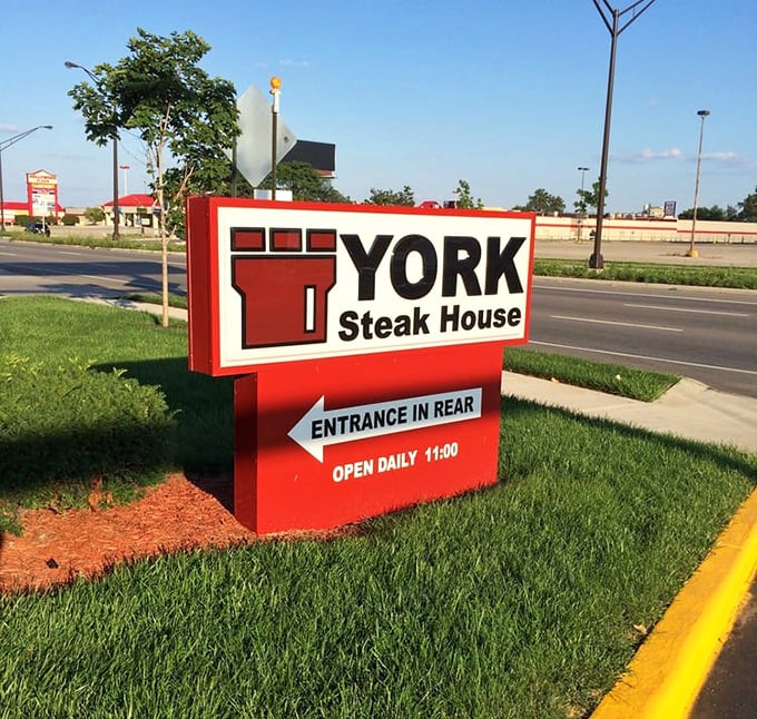 The roadside sign stands as a beacon for hungry travelers and locals alike—a red and white promise that some traditions are worth preserving.