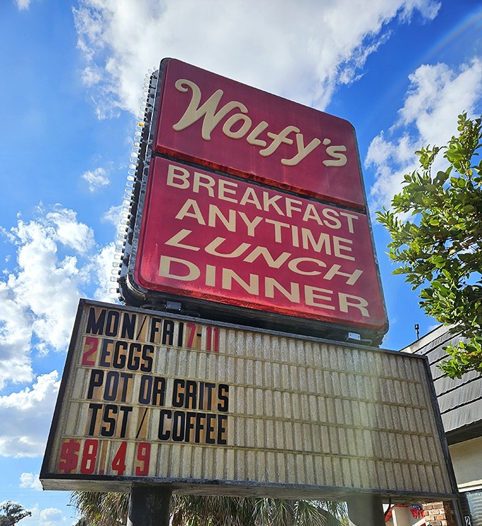 The iconic Wolfy's sign against Florida's blue sky—a beacon of hope for the hungry and a landmark for locals in the know.