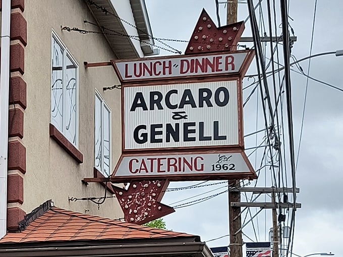 The vintage sign stands as a beacon of hope for hungry travelers—follow the arrow to pizza paradise.