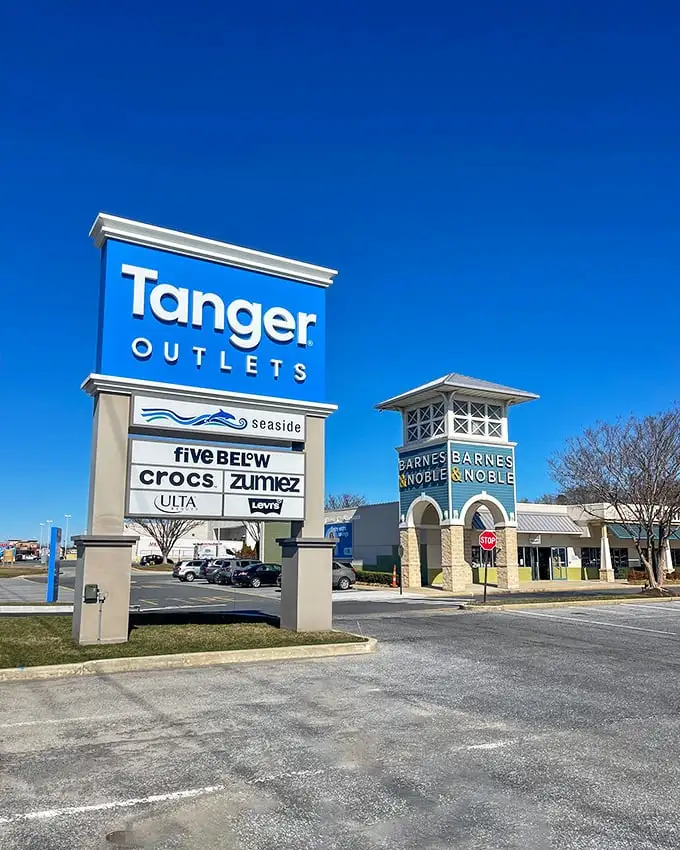 The gateway to bargain paradise. Tanger's iconic blue sign promises a day of retail therapy that won't require actual therapy afterward.