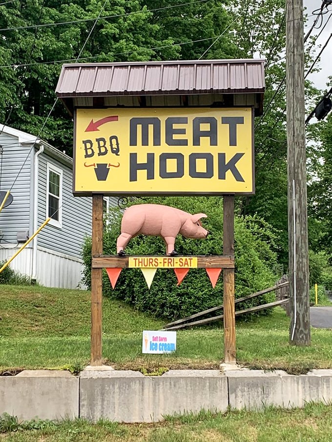 A roadside sign with a pig that knows its destiny and seems surprisingly okay with it.
