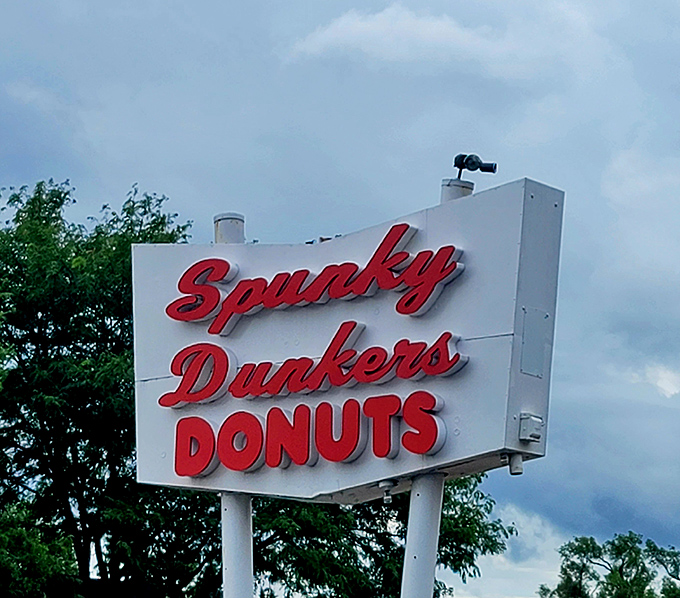 The roadside sign that's guided hungry travelers for years, its red letters practically shouting what your stomach is already whispering: "DONUTS!"
