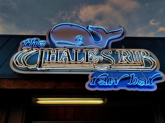 The neon whale sign glows against the twilight sky – a beacon for hungry travelers and a landmark for locals who know what's good.