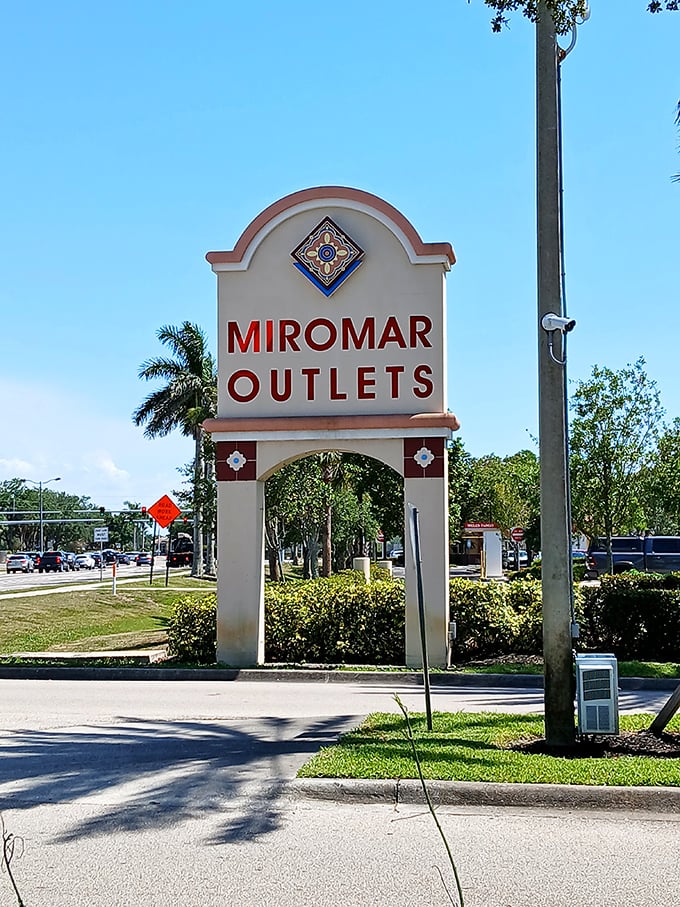 The iconic entrance sign stands as a retail lighthouse, guiding bargain hunters safely to the shores of discount paradise.