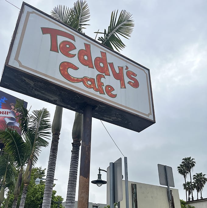 That classic diner sign standing tall, like a lighthouse guiding hungry souls to breakfast salvation.