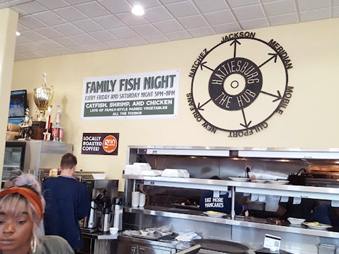 Where the magic happens—a kitchen wall adorned with local pride and the promise of "Family Fish Night" that has locals blocking their calendars weeks in advance.
