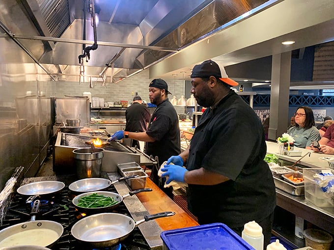 Where the magic happens – skilled hands transforming simple ingredients into the comfort food masterpieces that keep locals coming back.