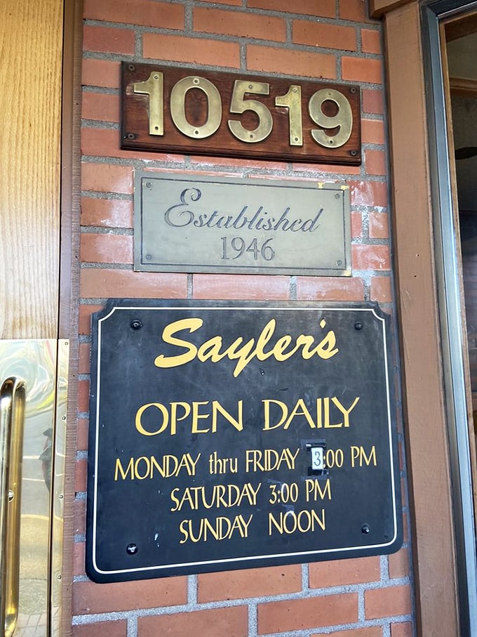 The brass numbers and hours sign—a portal to simpler times when restaurants didn't need websites, just perfectly cooked ribeyes.