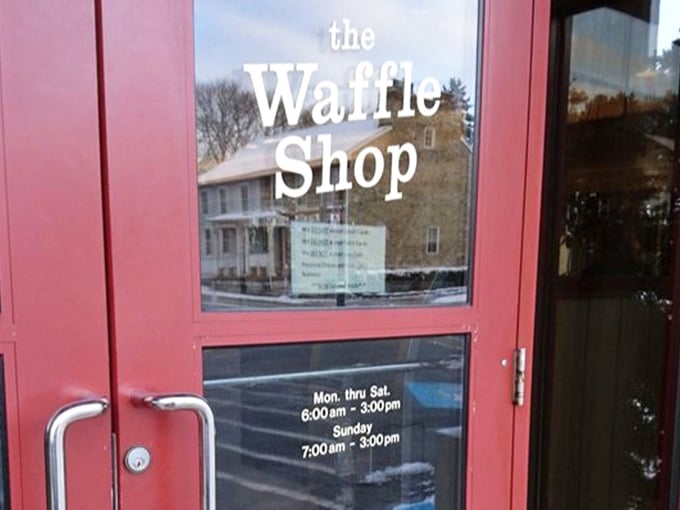 The red door announces operating hours like a breakfast invitation – come early, come hungry, and prepare to join the clean plate club.