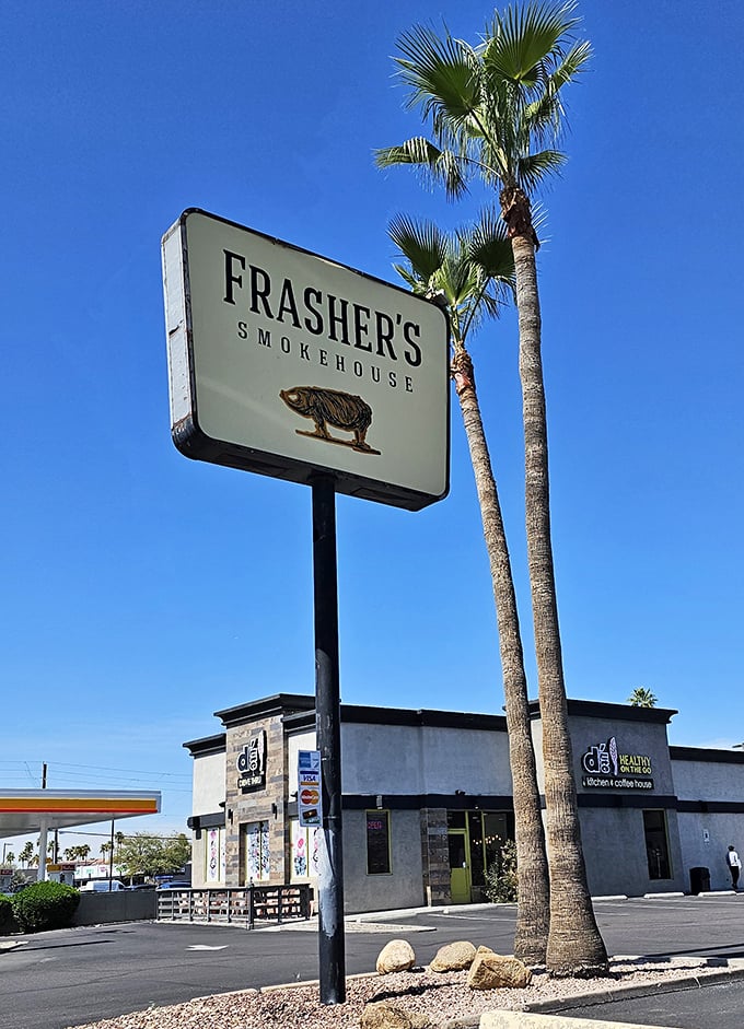 Palm trees frame the Frasher's sign—a uniquely Arizona take on BBQ paradise. Desert heat meets smoker heat in perfect harmony.