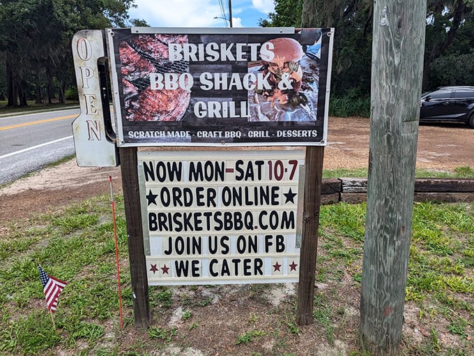 The roadside sign beckons like a smoky siren call to hungry travelers. "Detour for deliciousness," it practically whispers.