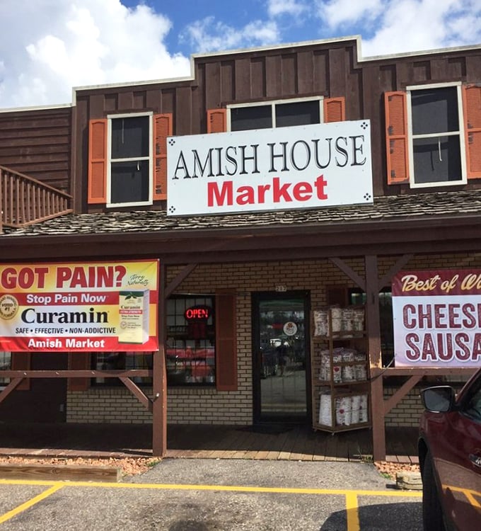 The Amish House Market exterior—where culinary adventures begin. That "Got Pain?" sign is ironic because this place is pure pleasure.