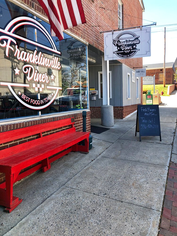 The red bench outside says "Welcome" before you even step inside. Small town charm with a side of American flag—classic diner DNA.